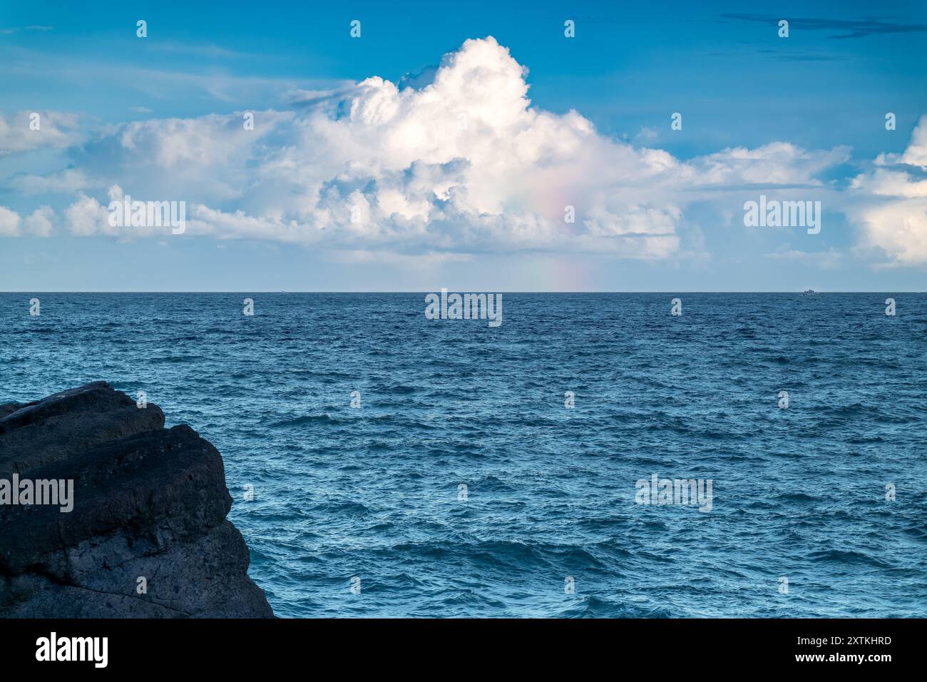 On a sunny afternoon, towering cumulus clouds cast huge shadows across ...