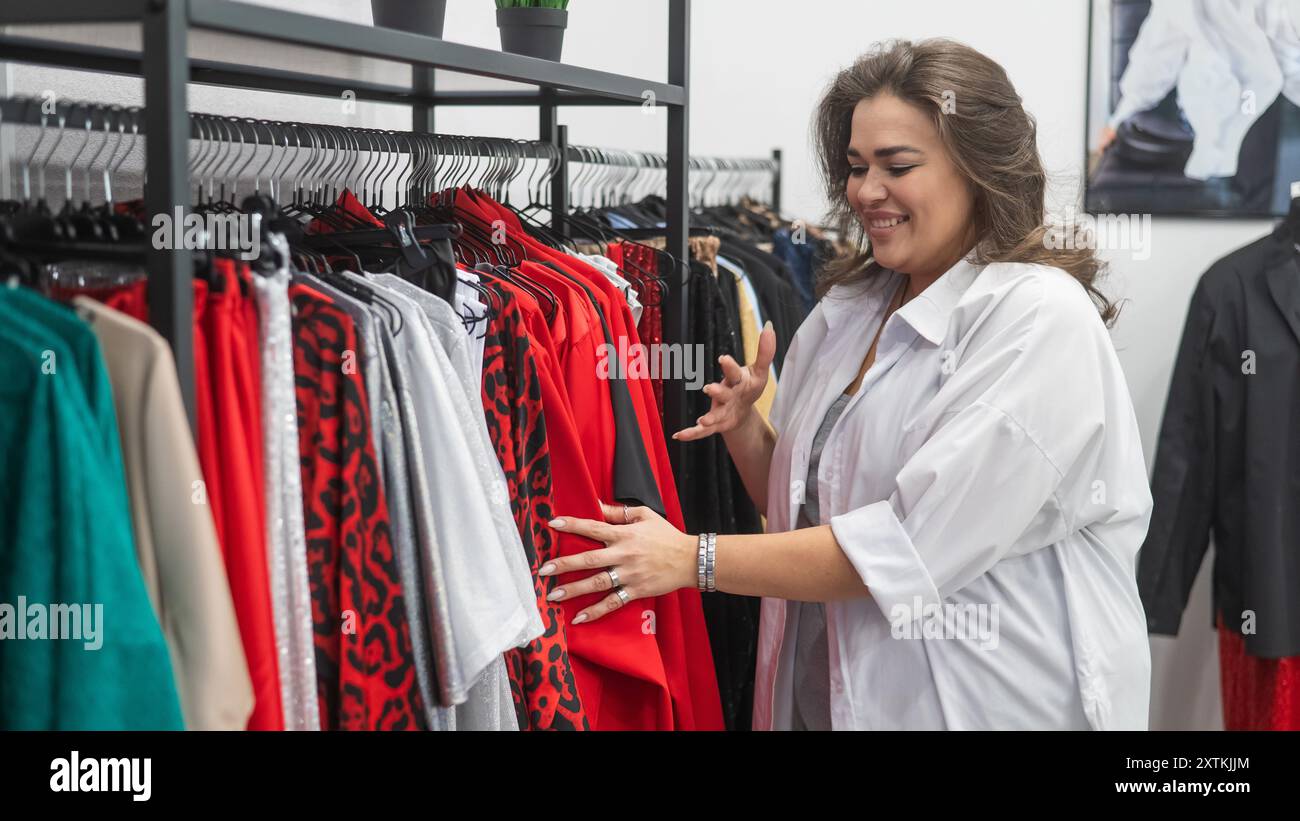 A fat woman chooses clothes in a plus size store Stock Photo - Alamy