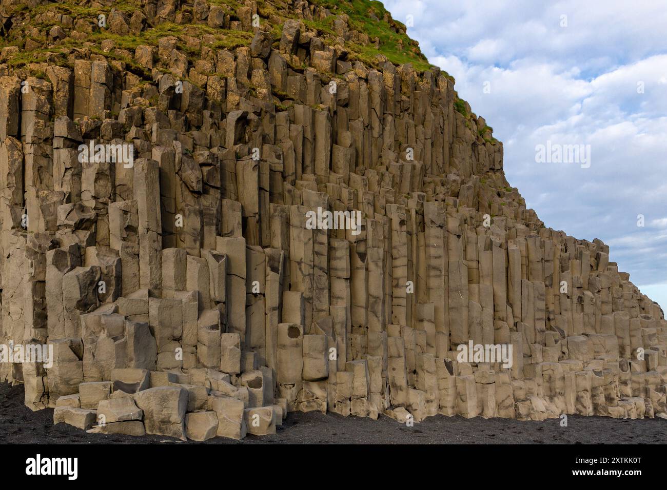 Basalt hexagonal columns rock formation on Reynisfjara Black sand beach, Iceland Stock Photo - Alamy