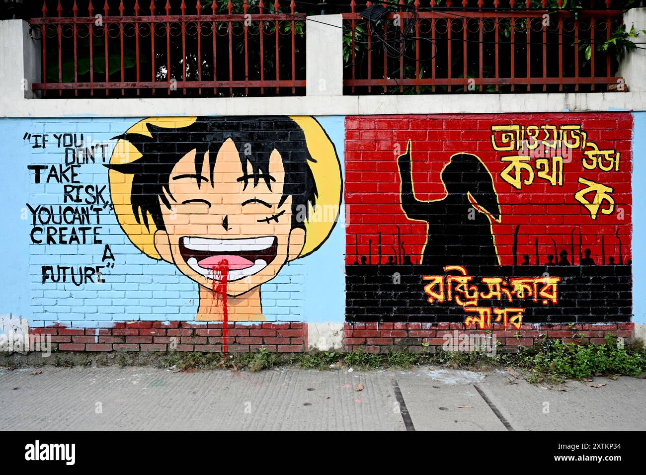 A view of Students paint graffiti on a wall alongside a road to express their voices after the ...