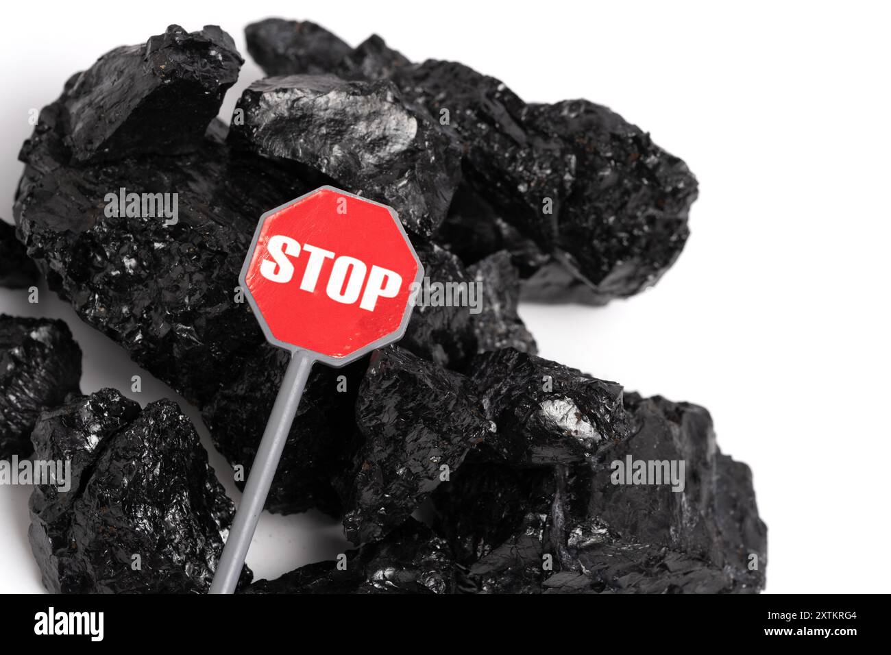 Pile of coal isolated on white background with stop sign. Concept of ...