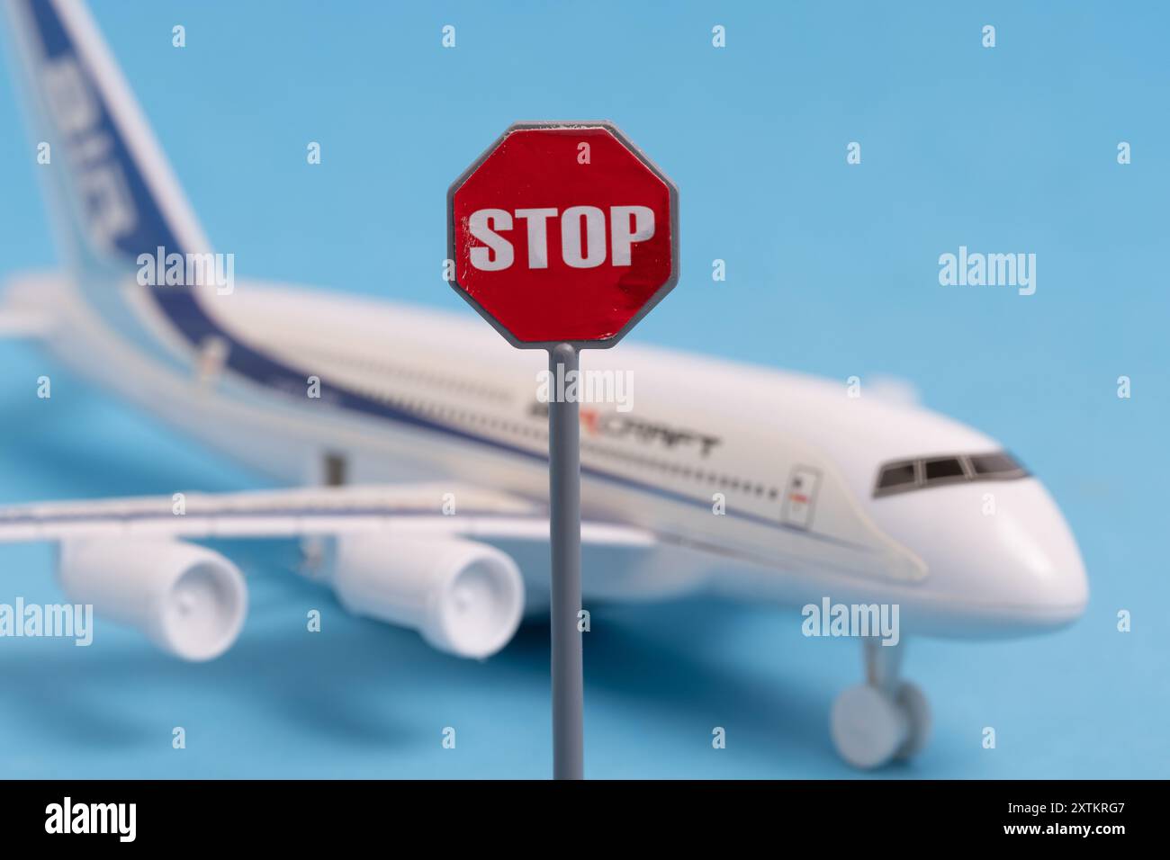 Travelling concept. Airplane and stop sign on blue background Stock ...