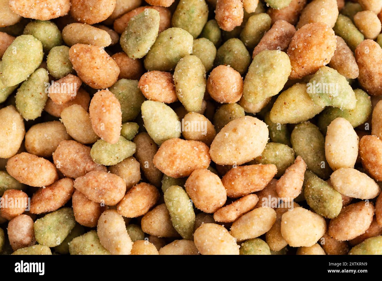 Closeup side of roasted peanuts in colored glaze, which can be used as ...