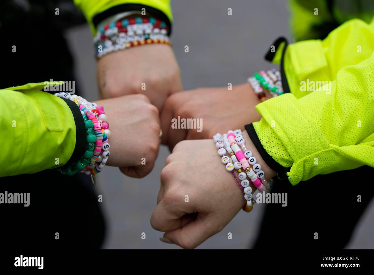 Four police officers show their wrist bands that have names of Swift ...