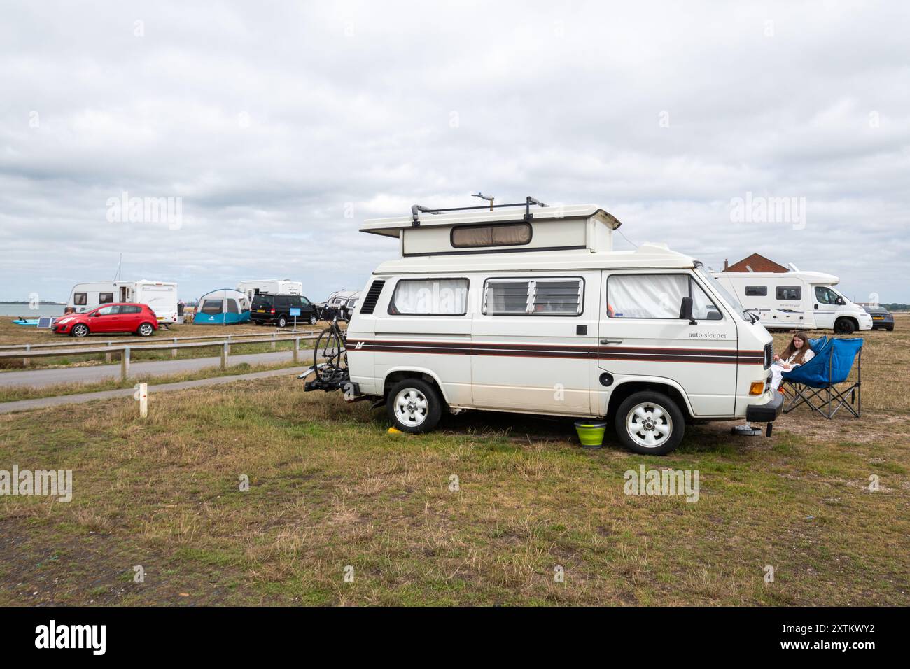 Campervans or campers staying beside Calshot beach on the south coast in summer, Hampshire ...
