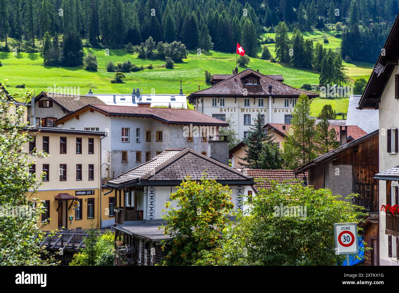 The Swiss flag flies over the Hotel Weisses Kreuz. Fuschena, Bergün ...