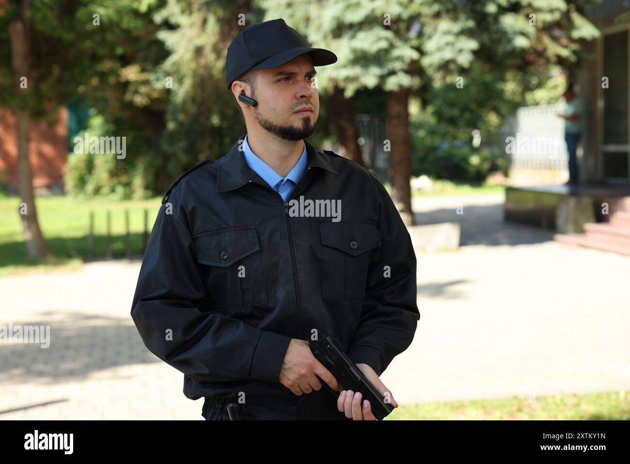 Security guard in uniform with gun outdoors Stock Photo - Alamy