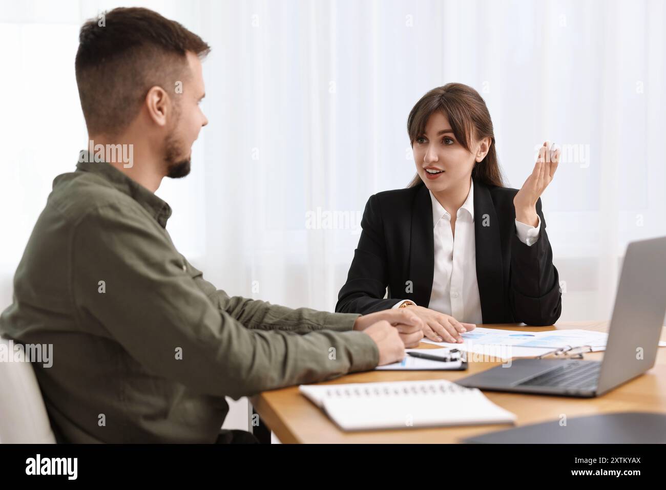 Consultant working with partner at table in office. Business meeting ...