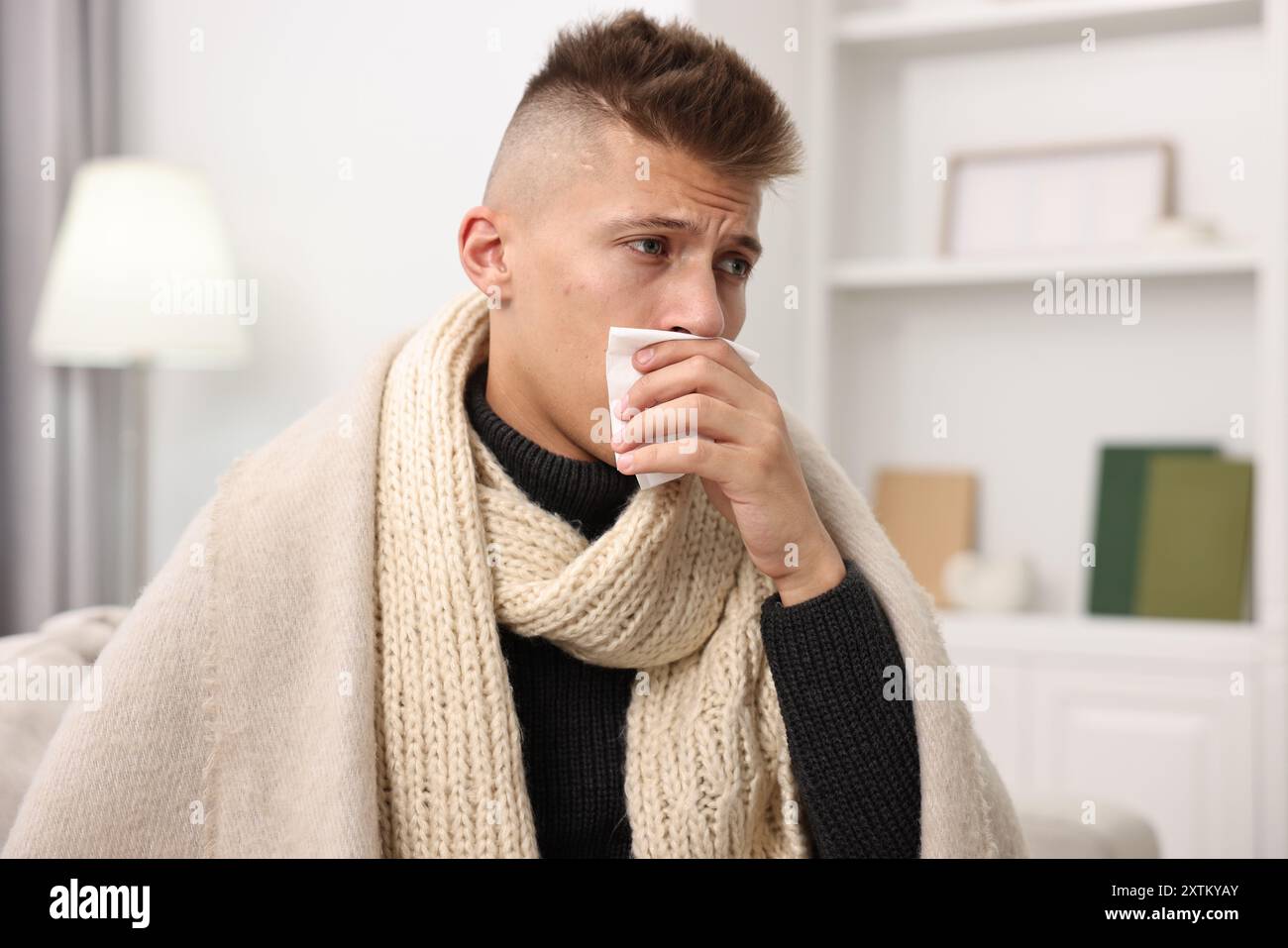 Cold symptom. Young man suffering from fever at home Stock Photo - Alamy