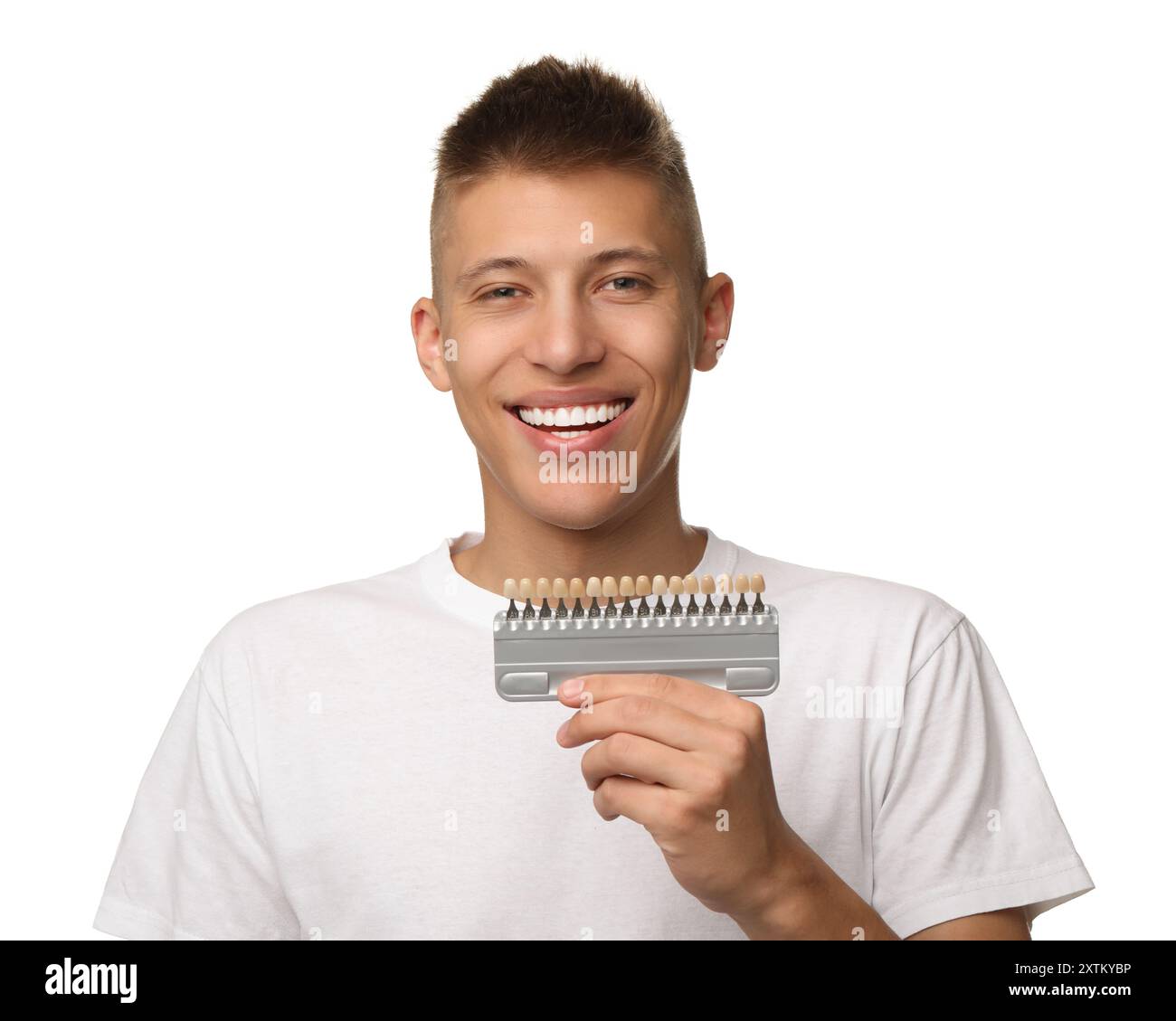 Happy young man with teeth color samples on white background. Dental ...