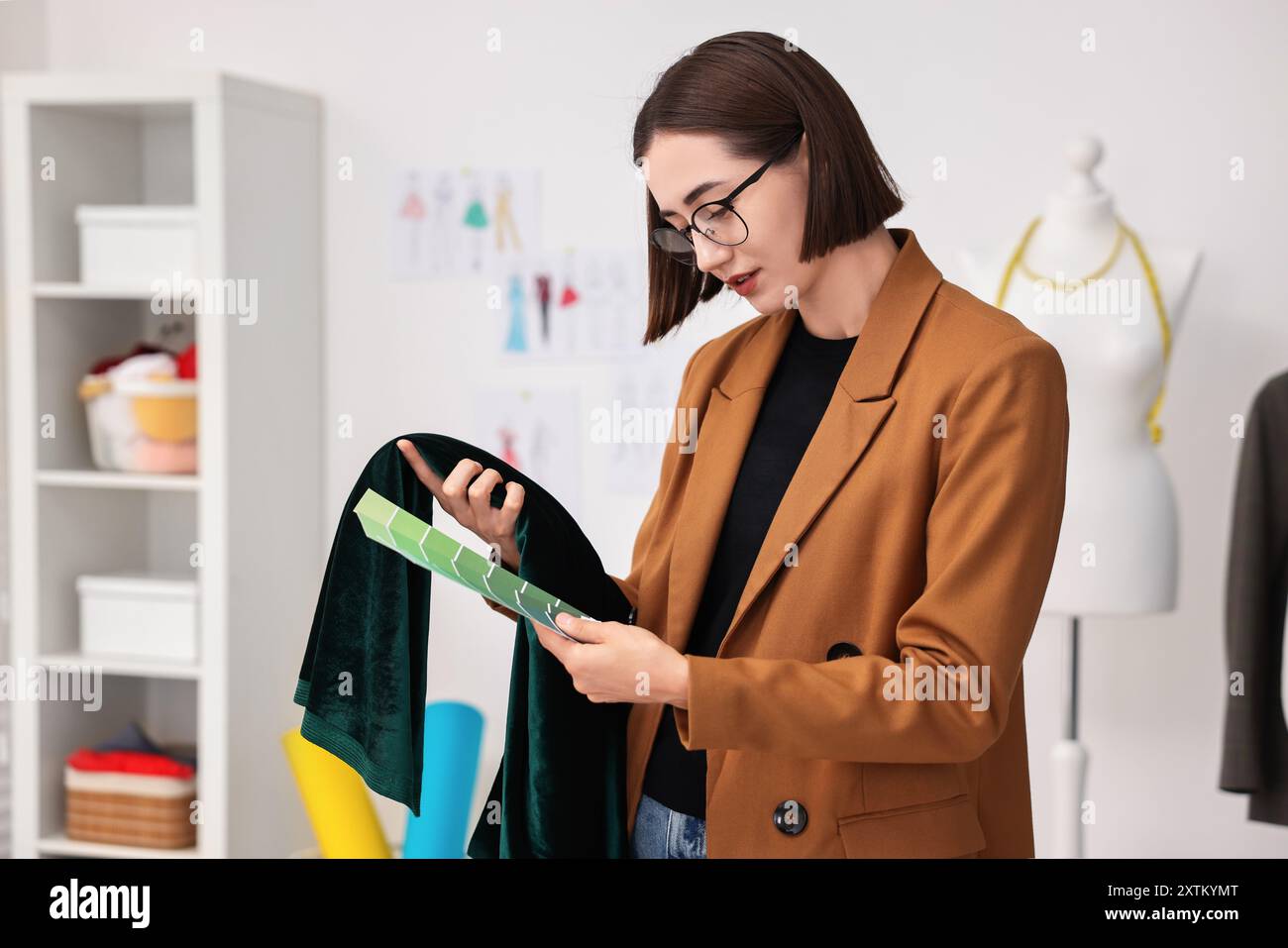 Fashion designer with color palettes and fabric in workshop Stock Photo ...