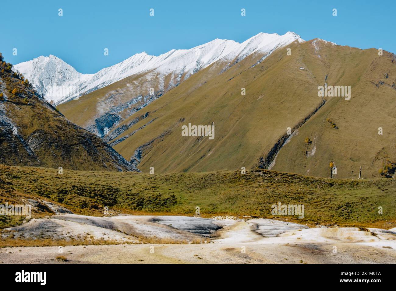 Travertines and snow capped mountains of the Caucasus in the Truso ...