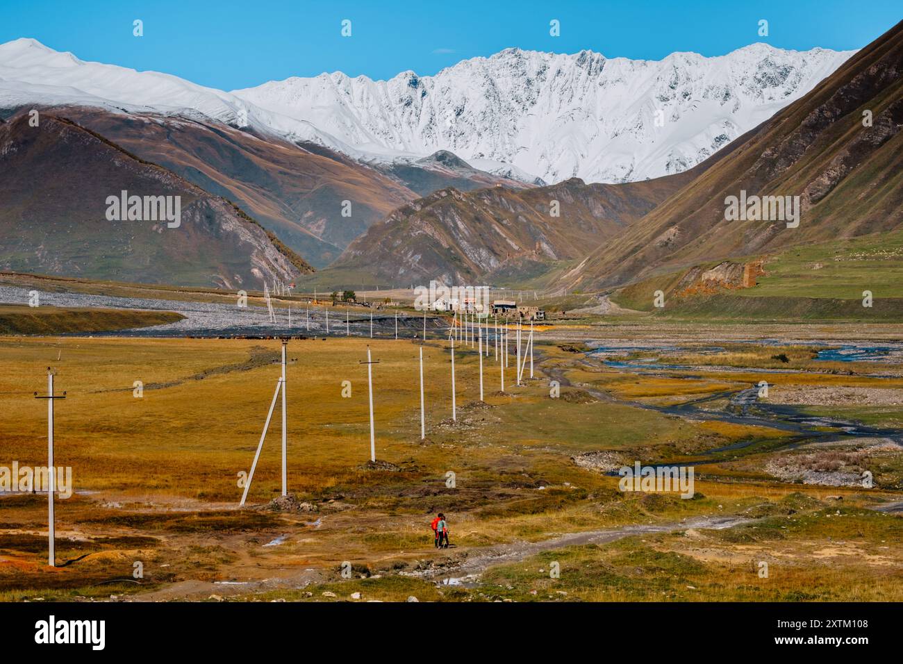 Vibrant landscape with the village of Ketrisi, snowy peaks, winding ...