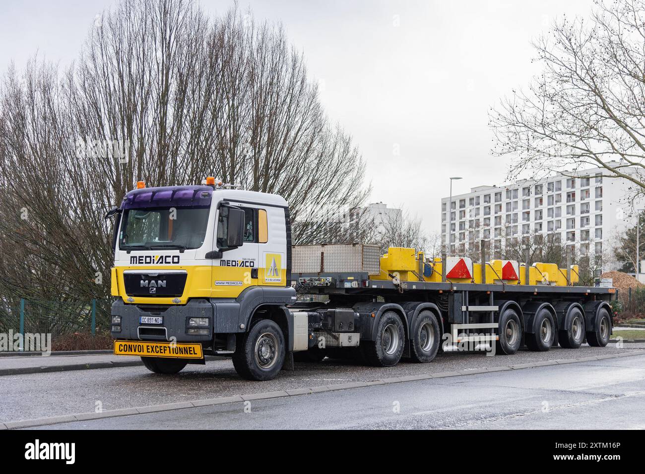 Vandœuvre-lès-Nancy, France - View on a yellow and white heavy haulage truck MAN TGS 33.480 with ...