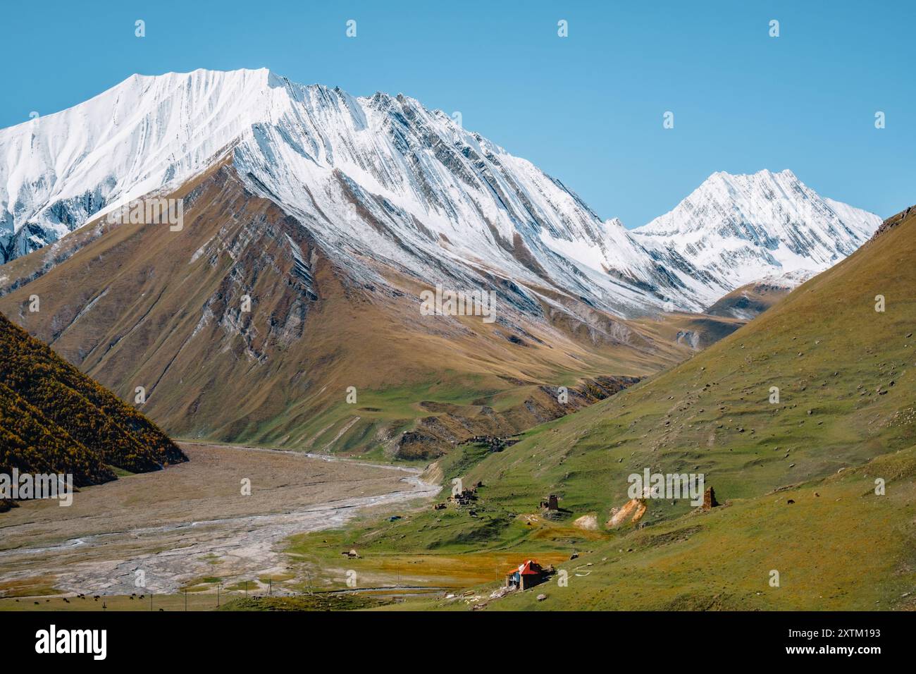 Sheperd's house and snow-capped mountains at the end of the Truso Gorge ...
