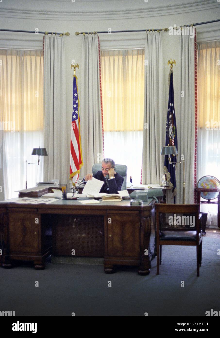U.S. President Lyndon Johnson at his desk, on telephone, Oval Office ...
