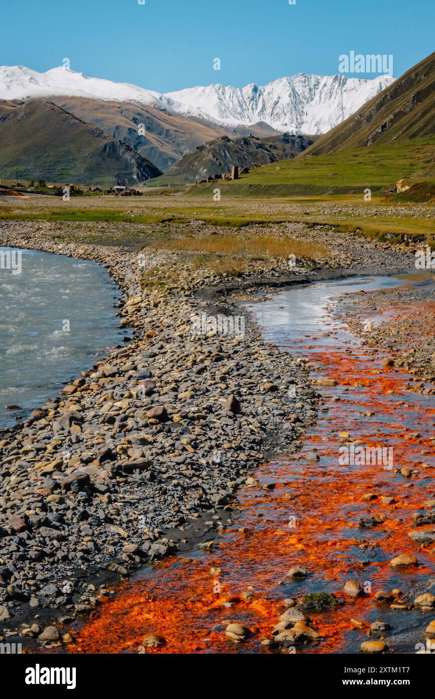 View of the blue and orange (iron-rich) waters of the Terek River, with ...