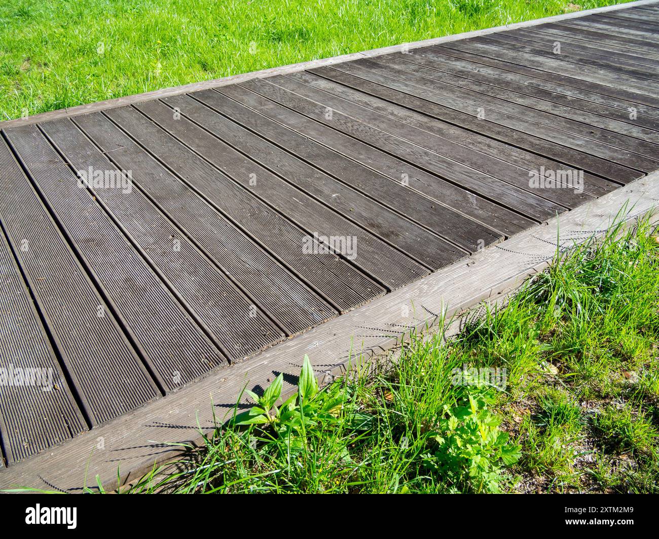 Wooden garden path made from decking boards Stock Photo - Alamy