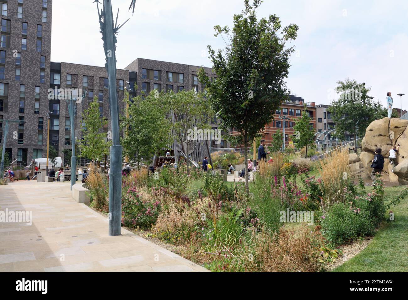 People sitting and children playing in Pounds park in Sheffield city ...