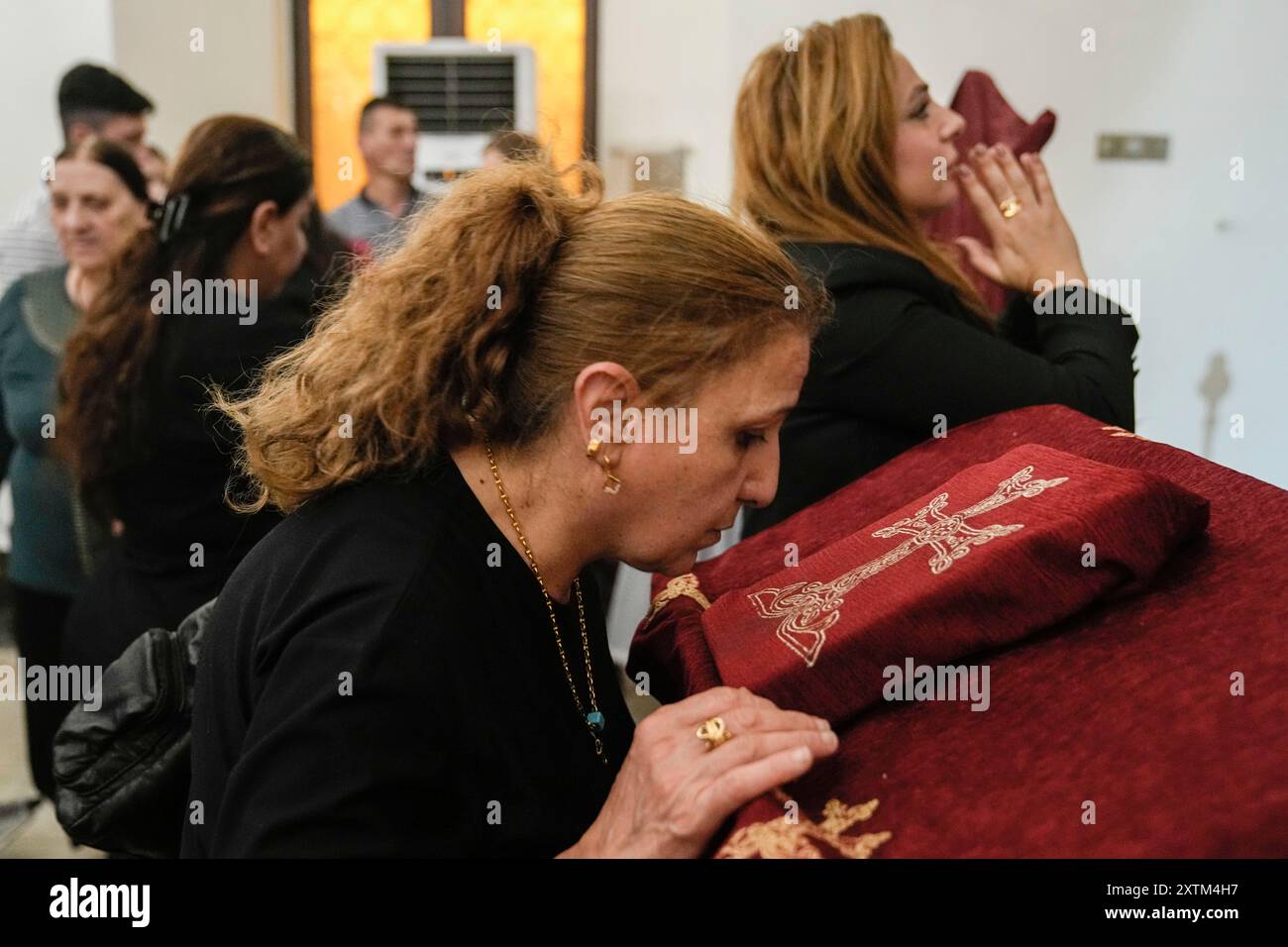 Iraqi Catholics pray during the feast day of the Assumption of Virgin ...