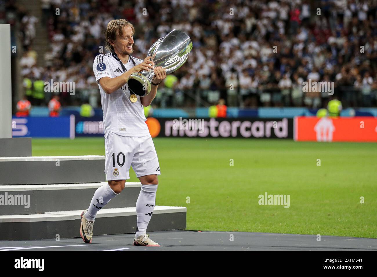 Luka Modric of Real Madrid holds a trophy during the ceremony after the ...