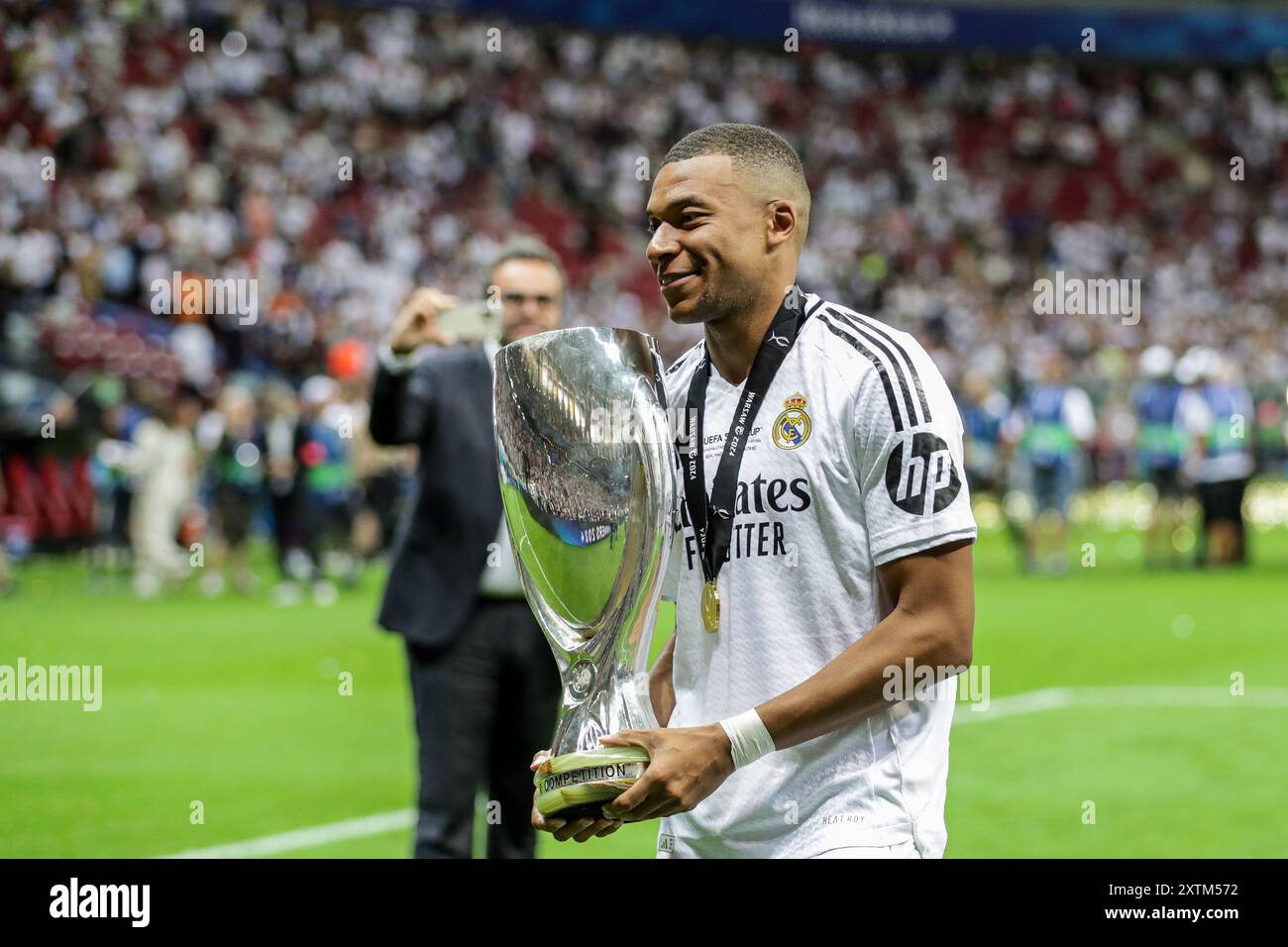 Kylian Mbappe of Real Madrid holds a trophy during the ceremony after the UEFA Super Cup 2024 ...