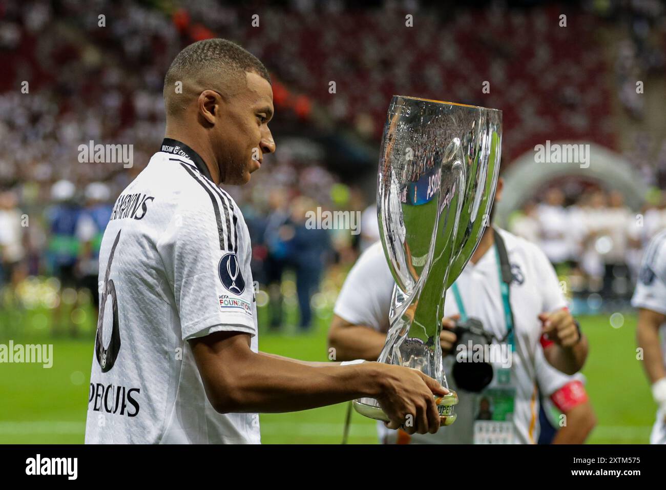 Kylian Mbappe of Real Madrid holds a trophy during the ceremony after the UEFA Super Cup 2024 ...