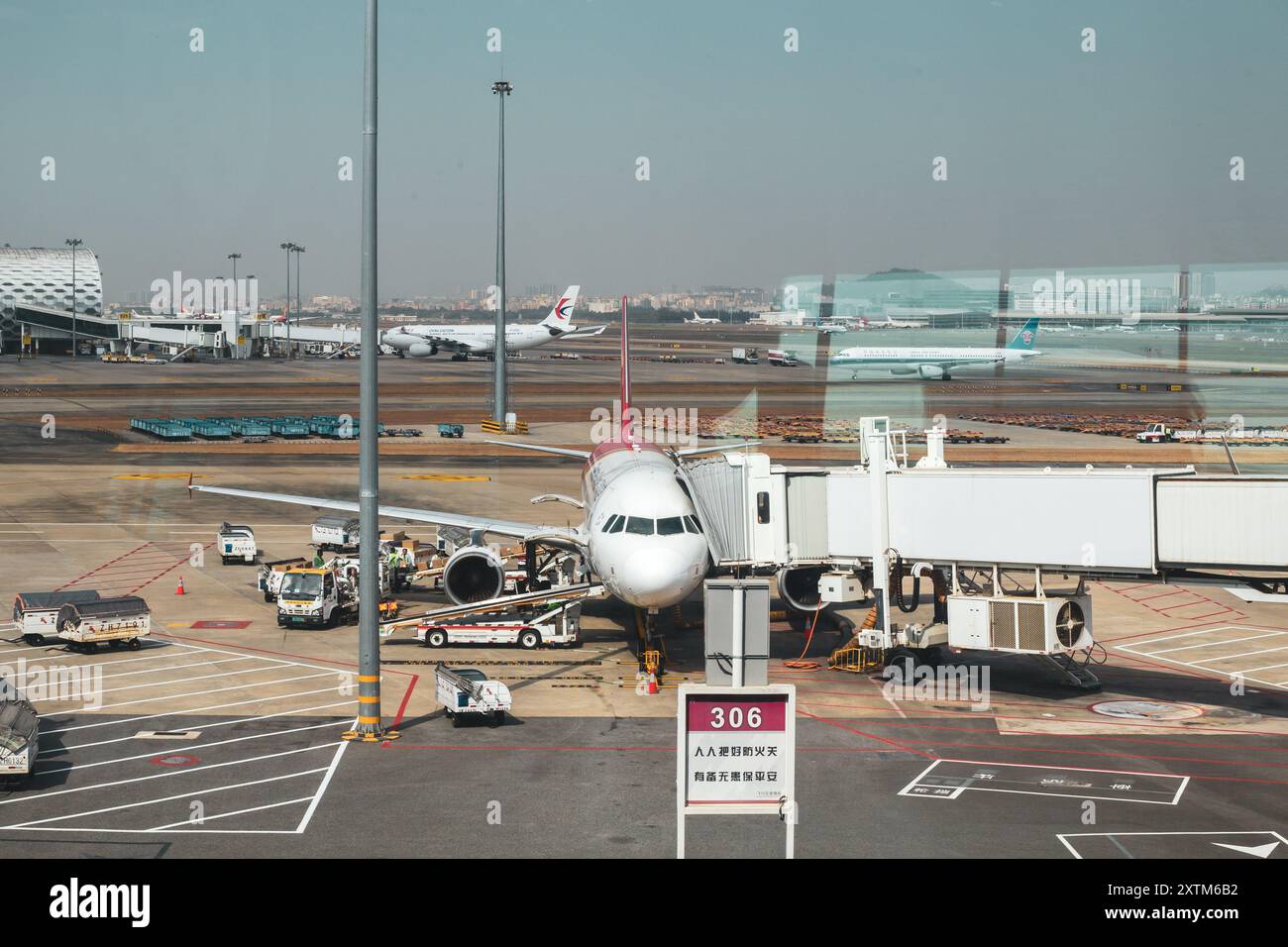 Airplane and maintenance equipment near the airport building, view from ...