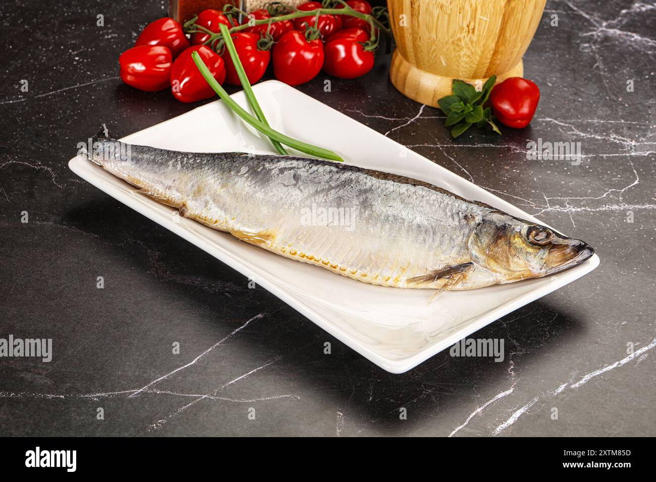 Whole raw salted herring fish in the plate Stock Photo - Alamy
