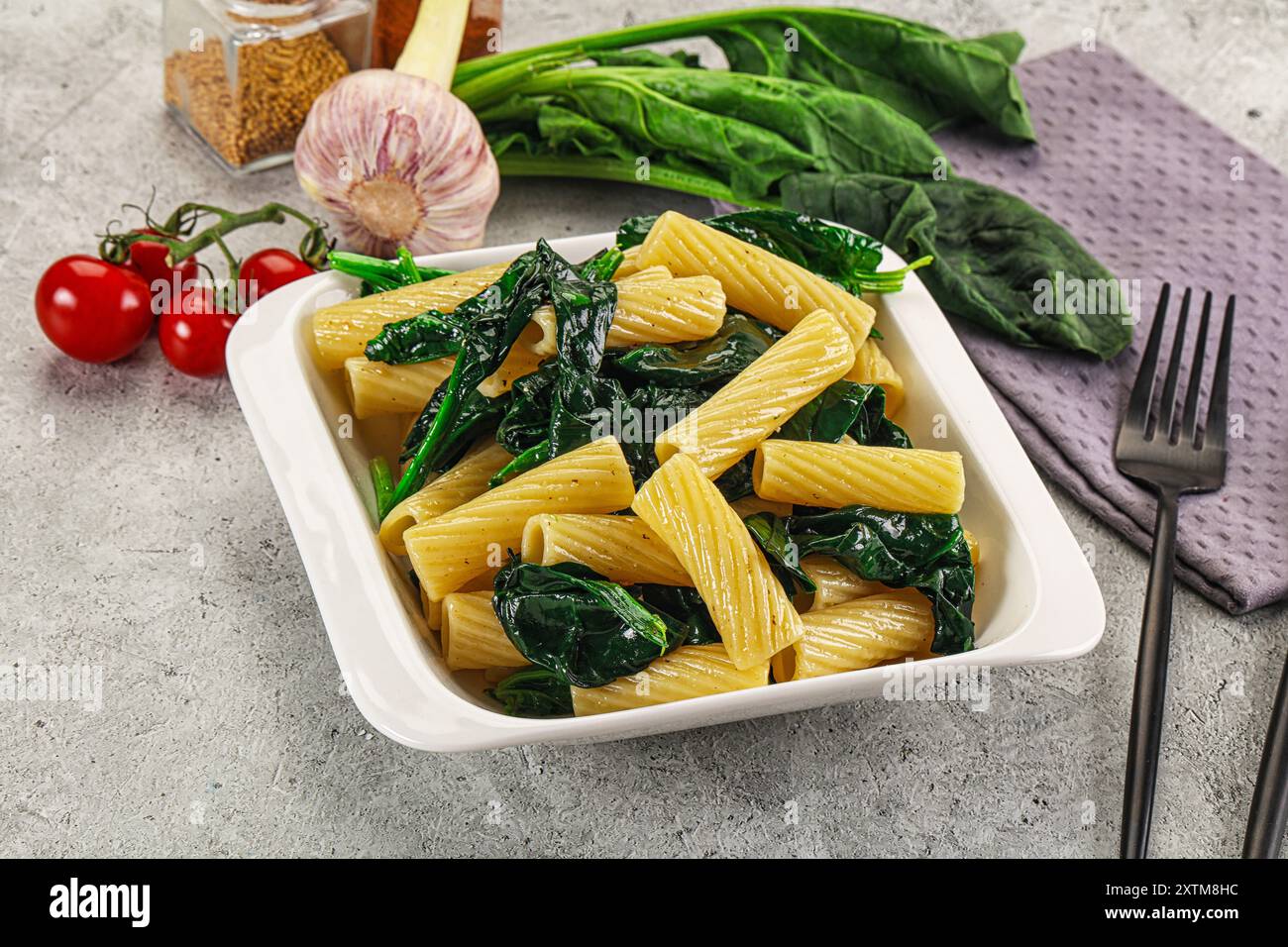 Italian cuisine - pasta tortiglioni with spinach Stock Photo - Alamy
