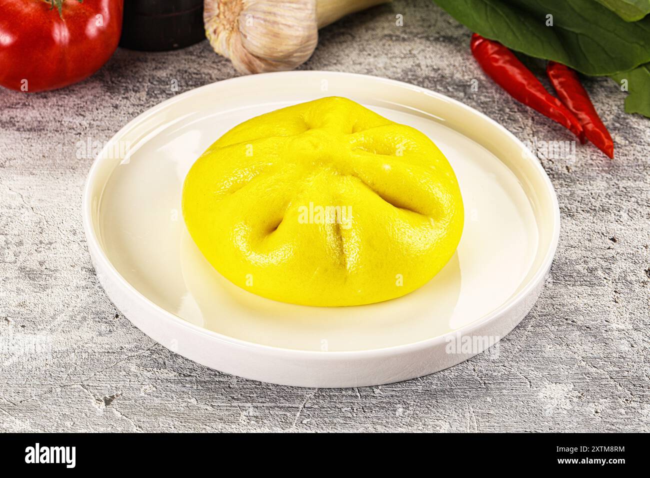 Asian stuffed steamed yellow Bun Bao Stock Photo - Alamy