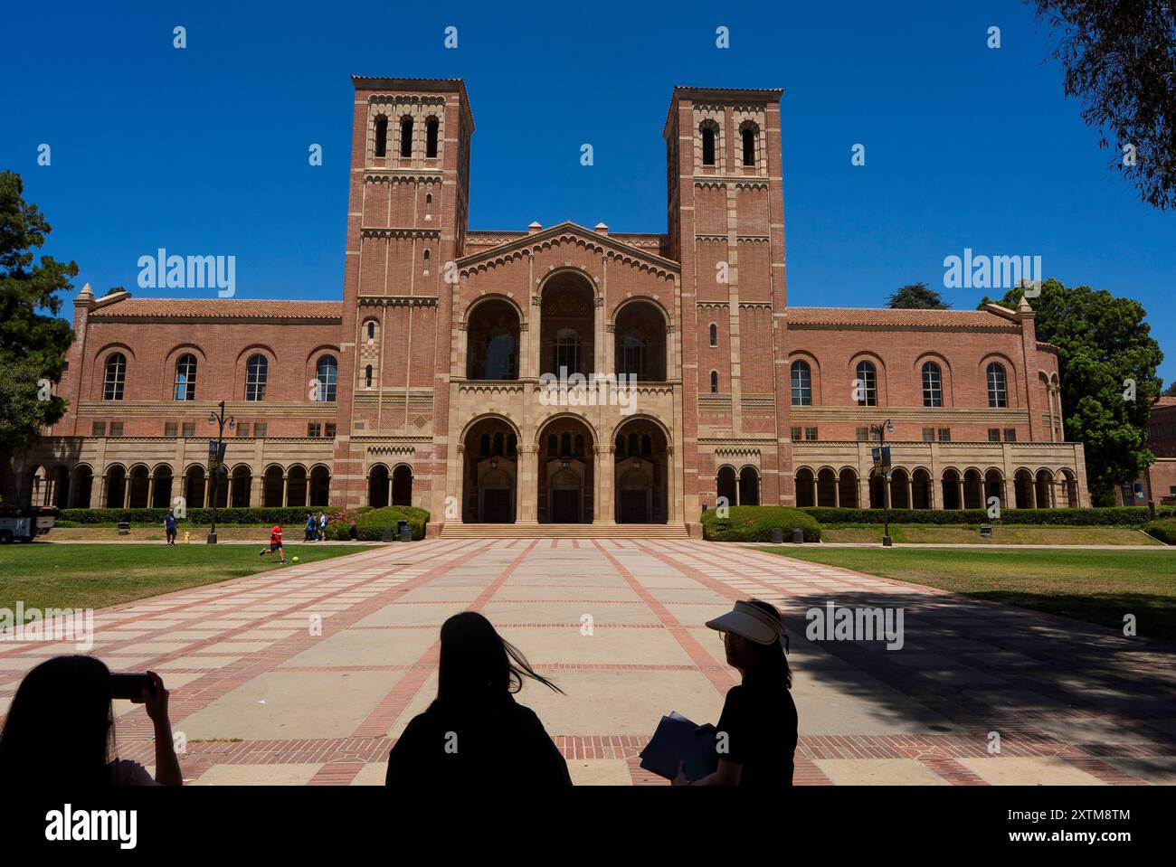 Visitors take pictures in front of Royce Hall at the University of ...