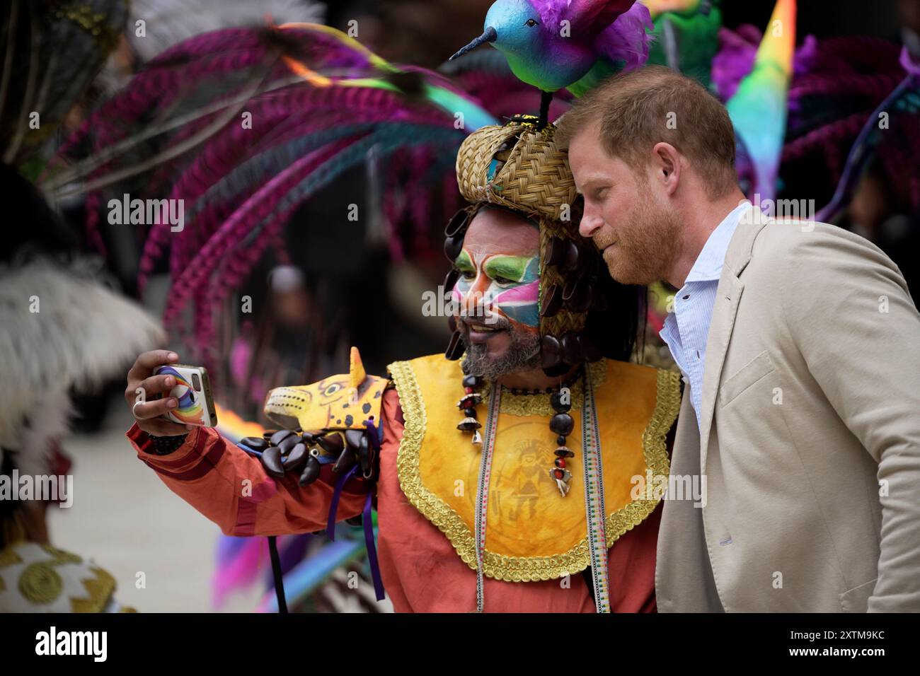 Prince Harry poses for a selfie with a traditional Carnival dancer ...