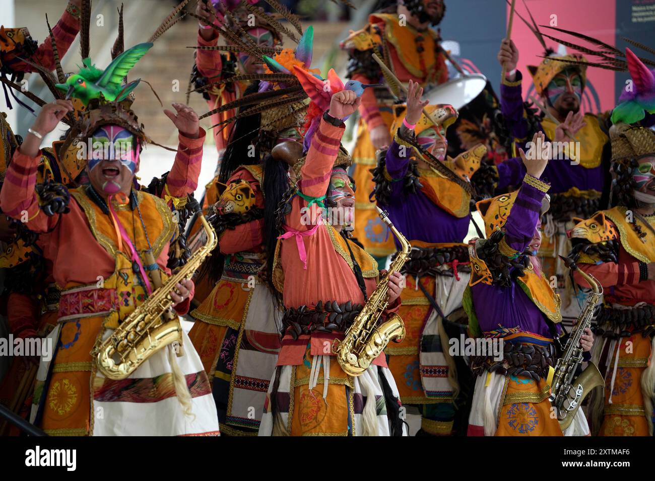 Musicians wearing traditional Carnival dress perform during a welcoming ...