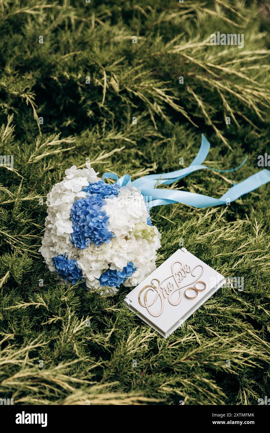 Elegant wedding details with floral bouquet and 'One Love' sign ...