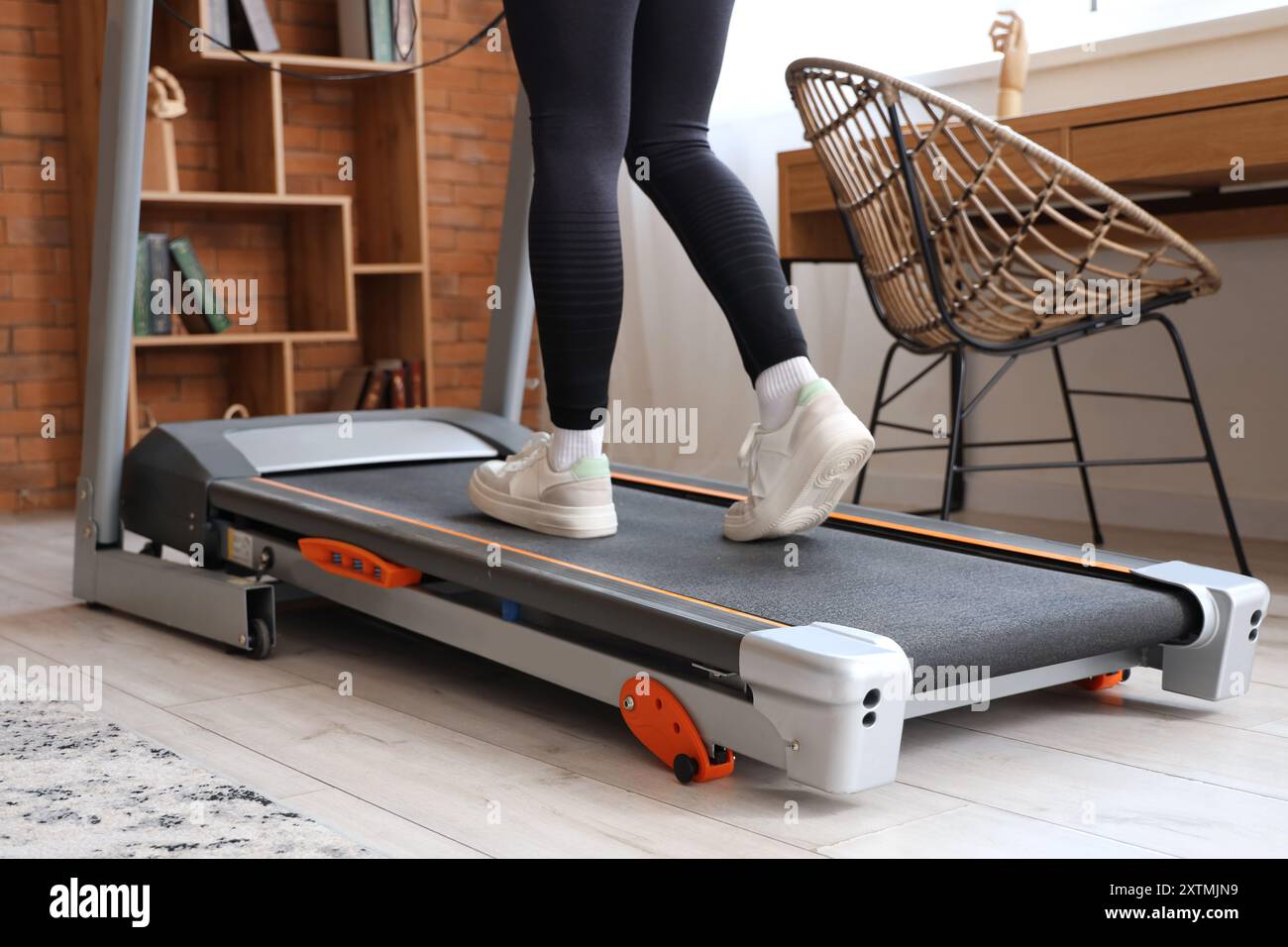 Sporty woman training on treadmill at home, back view Stock Photo - Alamy