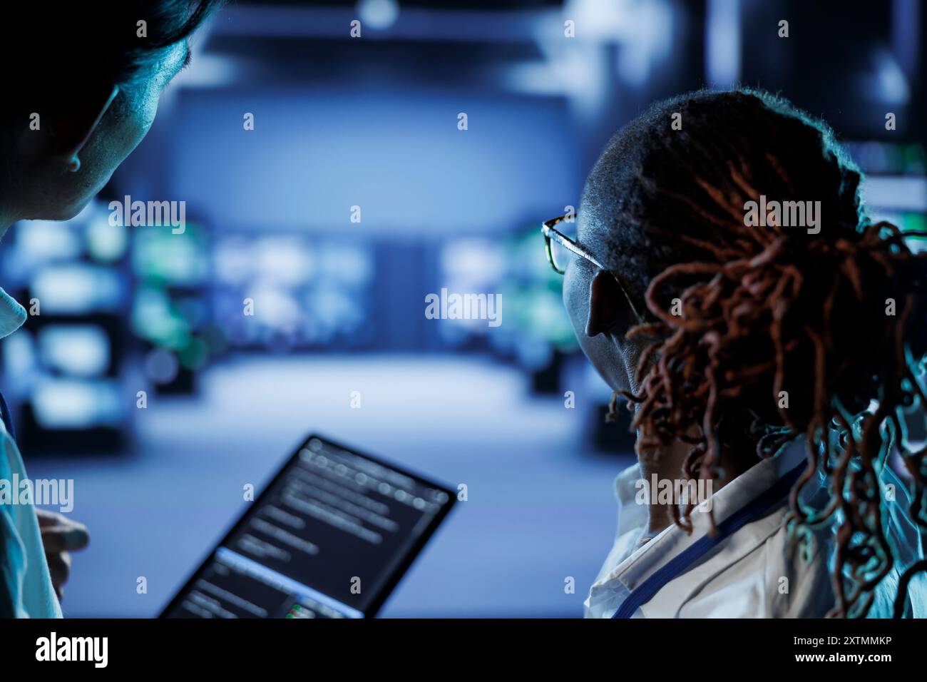 Team of engineers building firewall systems in server room housing ...