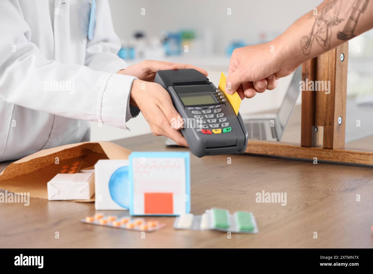 Female pharmacist receiving payment for order from customer at pharmacy ...