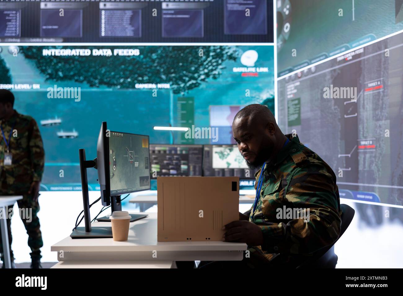 Army crew officer in a control center oversees satellite data and missions details, providing ...