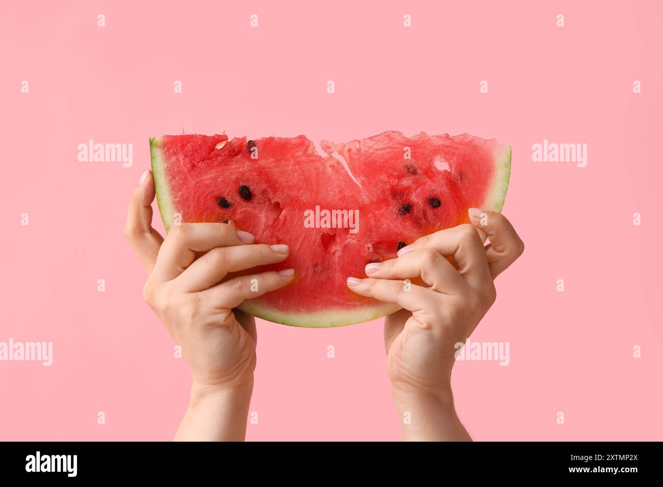 Female hands with slice of sweet watermelon on pink background Stock ...