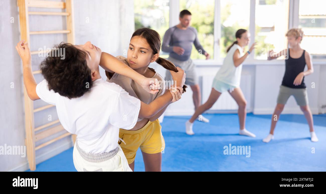 Boy and girl practicing self-defense techniques Stock Photo - Alamy
