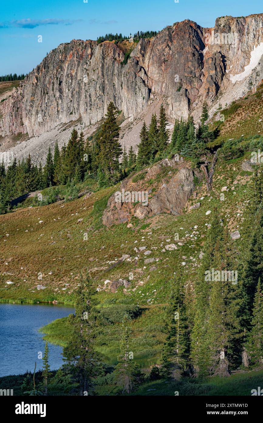 Mirror Lake sits below a mountain peak in the Snowy Mountain Range in ...