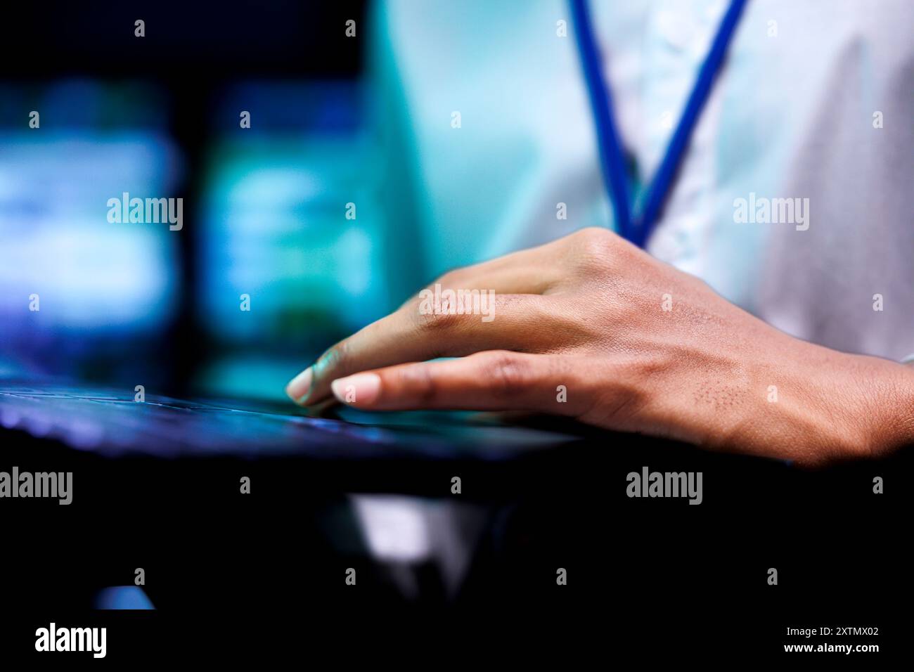 Extreme close up shot of employee using laptop in data center providing ...