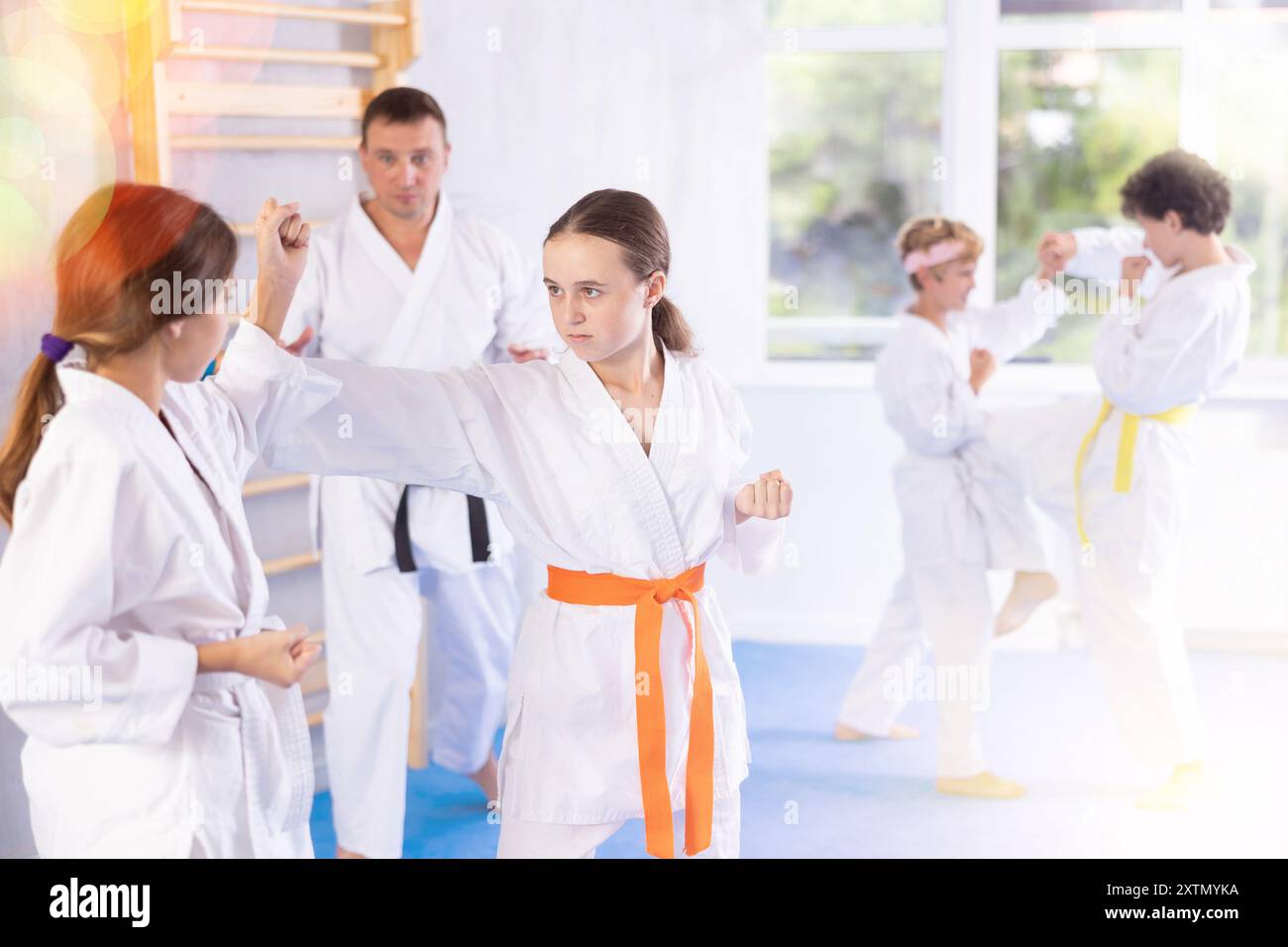 Karate children in kimono sparring together during their group karate ...