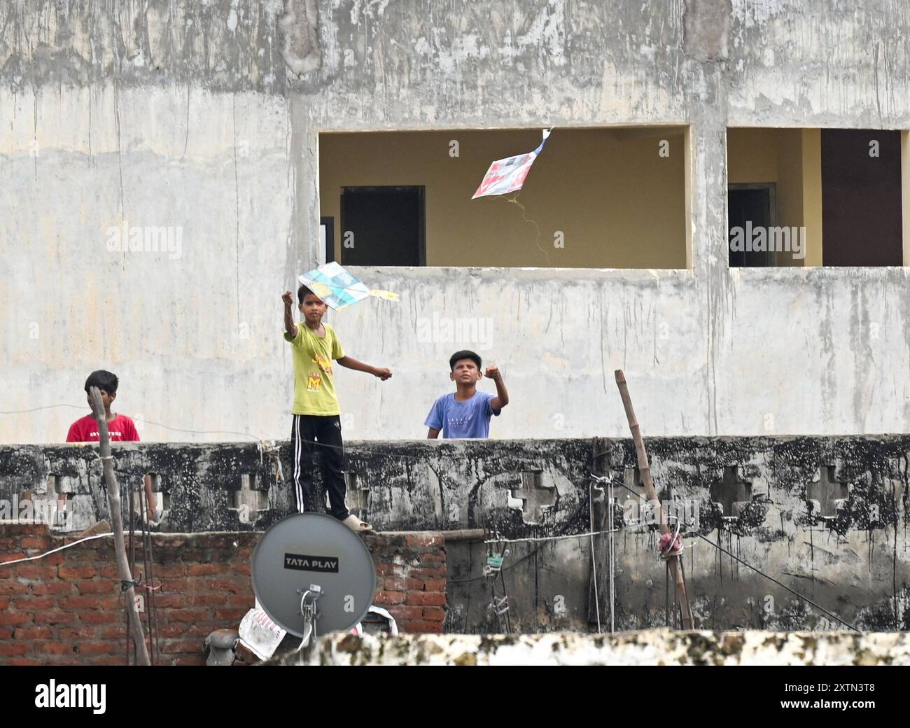 NOIDA, INDIA - AUGUST 15: People flying kites from rooftops on the ...
