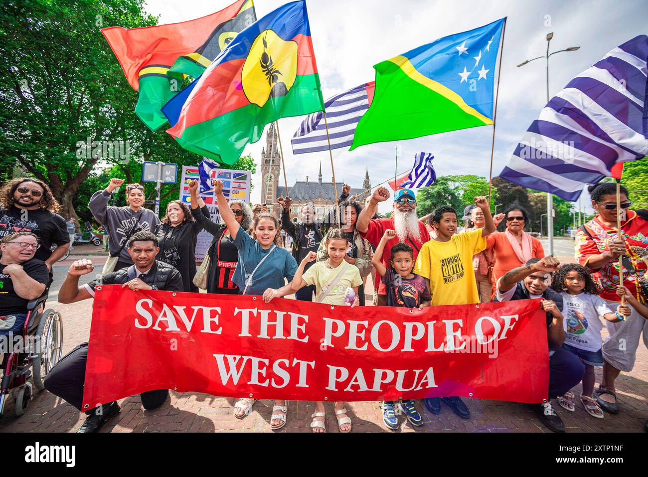 The Hague, Netherlands. 15th Aug, 2024. Protesters hold a banner and ...