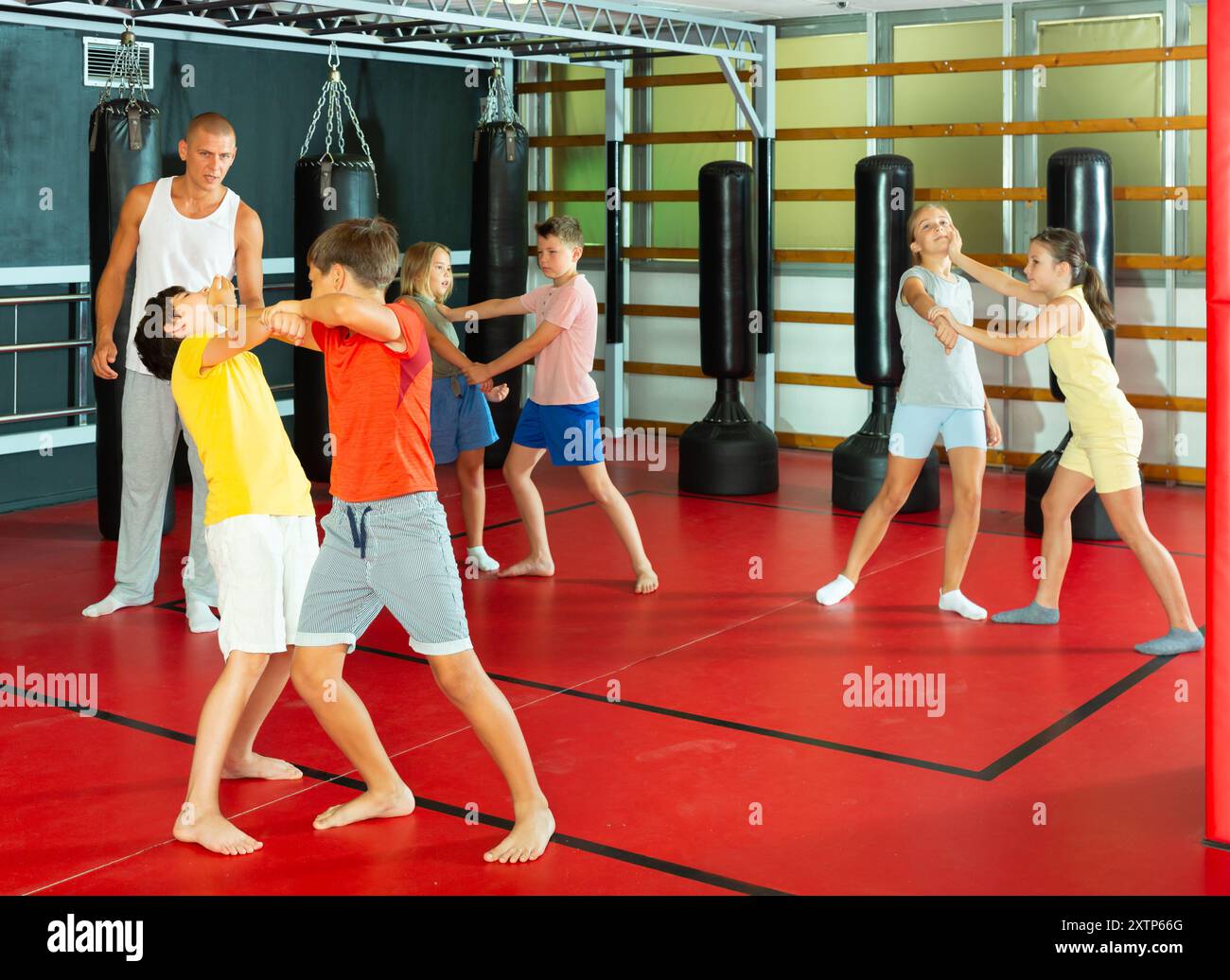 Kids in pair exercising self-defense movements Stock Photo - Alamy