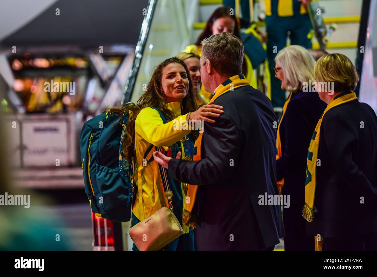 Jessica Fox (L) is welcomed by CEO of Australian Olympic Committee Matt ...