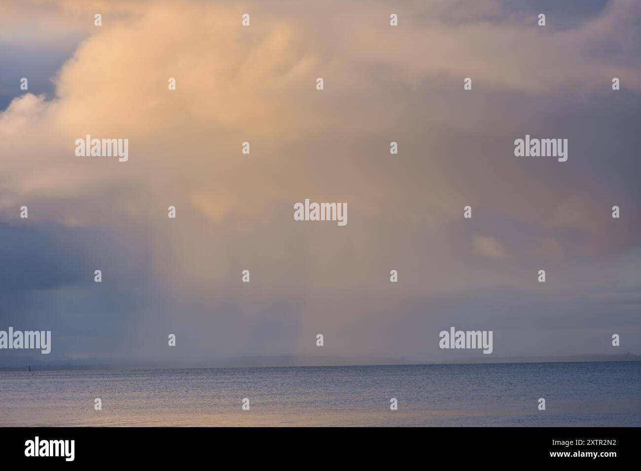 Heavy rain pouring from storm clouds into inner Hauraki Gulf viewed ...