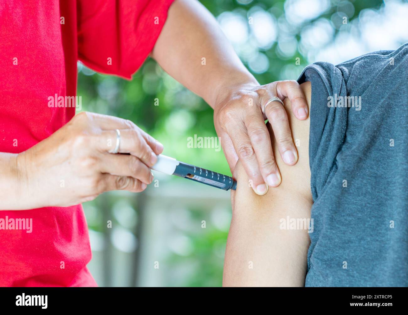 Women administering insulin to a diabetic patient at home. Insulin ...